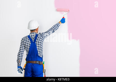 Back rear view of wall painters walking with paint buckets Stock Photo ...