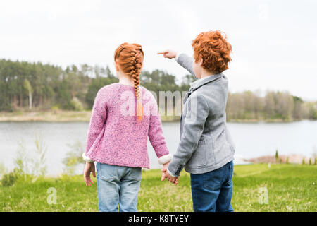 Children holding hands as a symbol of a brother and sister helping each ...