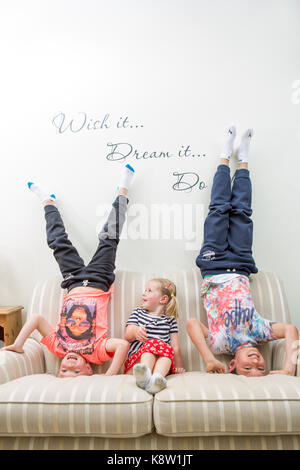 Girl doing headstand in garden Stock Photo - Alamy