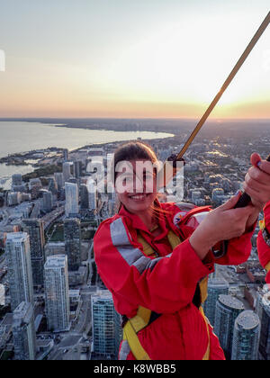 Toronto, Canada, Real people doing the EdgeWalk at the CN Tower late ...