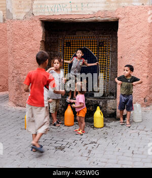Children playing in a trough of water in Rajasthan, India Stock Photo ...