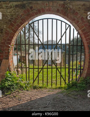The circular iron gate and Metal archway entrance to the impressive ...