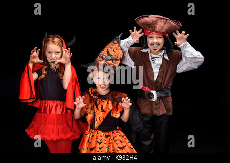 happy friends in halloween costumes over grey Stock Photo - Alamy