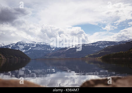 Scenic view of snowcapped mountain against cloudy sky Stock Photo - Alamy