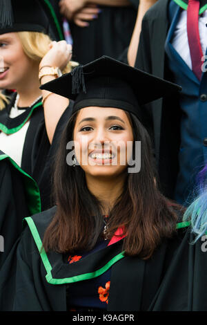 Female graduating students wearing gowns and mortar boards at the ...