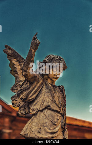 statue of young angel looking down Stock Photo - Alamy