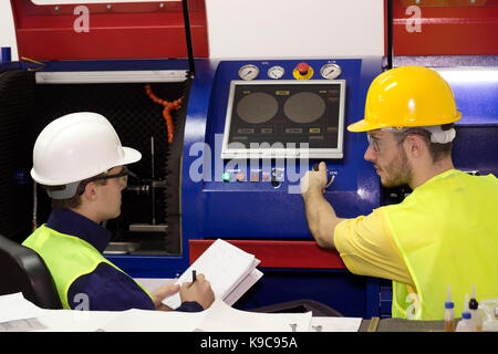 Machinists controls the operation of devices Stock Photo - Alamy