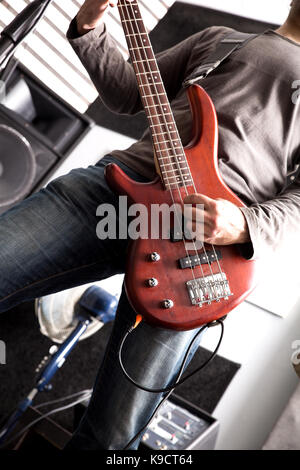 A Rock singer playing bass in the rehearsal Studio Stock Photo - Alamy