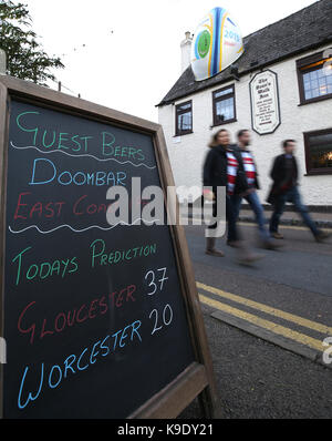 Spectators make their way to the stadium past The Dean's Walk Inn ...