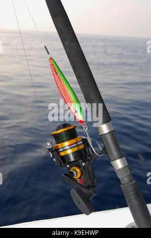 fishing rod and spinning reel and sea water background Stock Photo - Alamy