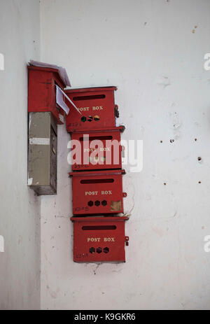 Red letter box with background of India Post, Pune University campus at ...