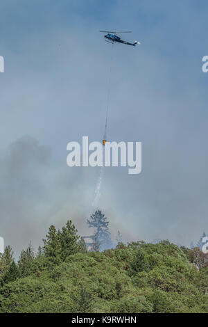 A CAL Fire retardant dropping airplane makes a drop along the ridge of ...