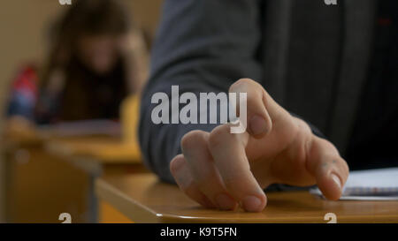 Student hand finger tapping closeup. Young man taps his fingers on a ...