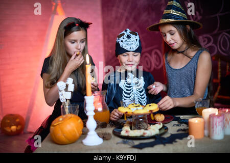 Eating Halloween treats Stock Photo - Alamy
