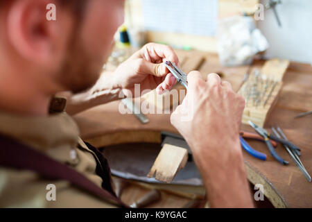 Stone setting in jewelry making production in the factory Stock Photo ...