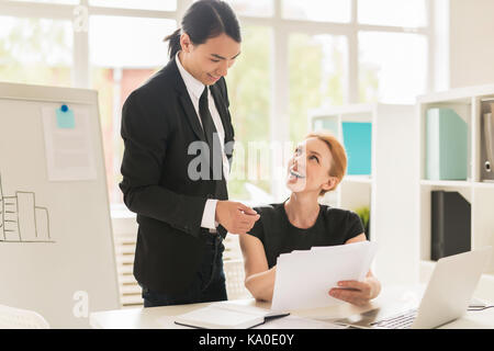 Office worker sharing ideas with his coworker Stock Photo - Alamy