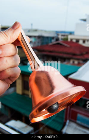 Indoor shot with outdoor background of someone (photographer) ringing a ...