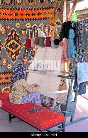 Turkish woman weaving carpets In Dalyan Stock Photo - Alamy
