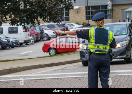 Police Community Support Officer directing a St John Ambulance driver ...
