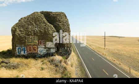 Yeager Rock, a large glacial erratic, lies along Hwy 172 near the town ...
