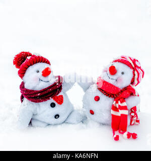 Couple of snowmen taking hand of each other Stock Photo - Alamy