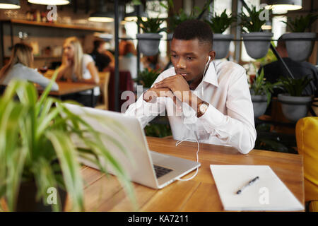 African handsome student working with laptop at the outdoor cafe Stock ...