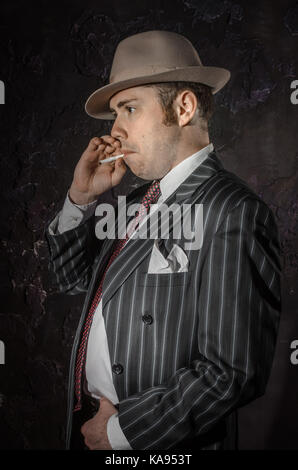 Private detective in old fashion hat smokes a cigarette. Gangster looks ...