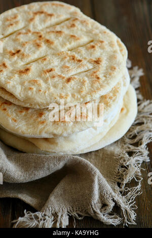 Stack of round pita flat-breads isolated on a white background, pita ...