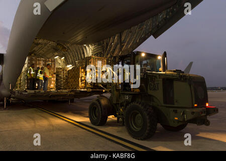 Members from 502nd Logistics Readiness Squadron load supplies onto a C ...