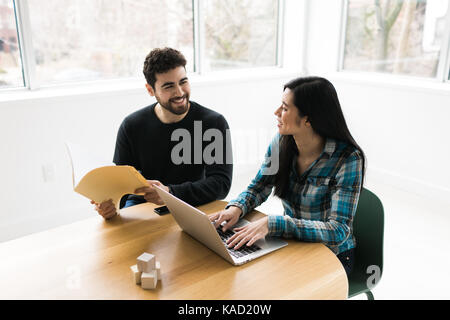 Two professional millennial Asian businesspeople working together in ...
