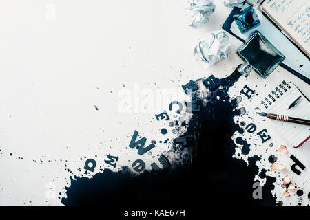 Writer workplace with spilled ink, crumpled paper, scattered letters ...