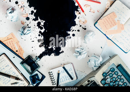 Writer workplace with spilled ink, crumpled paper, scattered letters ...