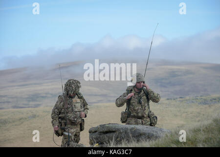 Soldiers from 6 RIFLES wait for orders on the range at Okehampton Camp ...