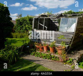 The old dilapidated wooden garden shed Stock Photo - Alamy