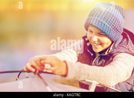 Teen boy setting up the tent at campsite on a summer day, young boy ...