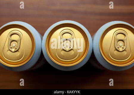 closeup photo of three beer cans on a wooden table Stock Photo - Alamy