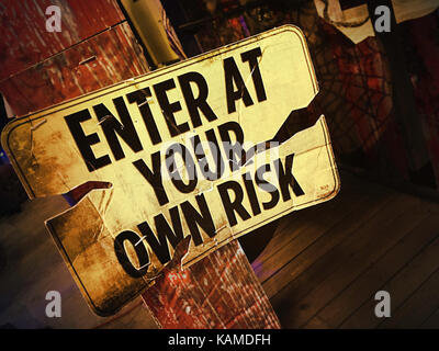 Enter at your own risk sign Stock Photo - Alamy