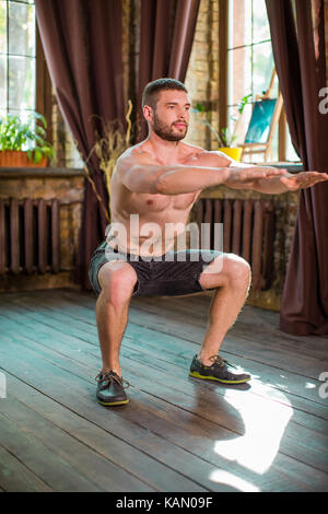 Fitness training, static exercises. Muscular man with laptop makes ...