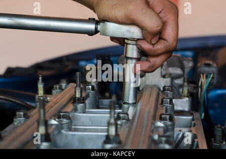 hand of mechanic with hand of mechanic with wrench torque to tightening ...