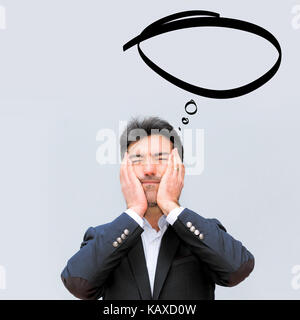 Portrait view of an attractive dubious business man with business icons ...