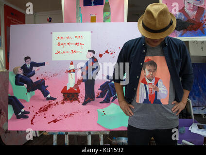 North korean artist sun mu in frot of a painting with donald trump and ...