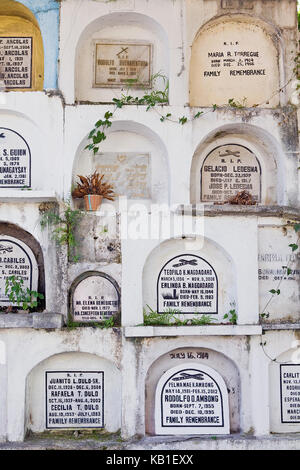 Concrete cemetery crypts stacked many levels high in a Philippine ...
