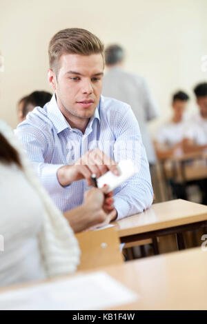 Students during test cheating with cheat sheet Stock Photo - Alamy