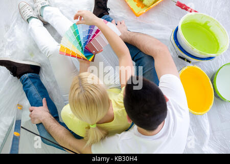 Girl looking at color swatches and choosing between them Stock Photo ...