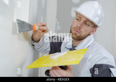 Focused Construction Worker Applying Smooth Finish to Fresh Concrete on ...
