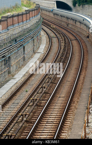 Perspective view of empty train tracks and concrete platform under ...