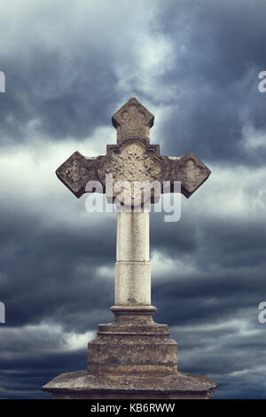 stone cross on dark sky background with Stock Photo - Alamy