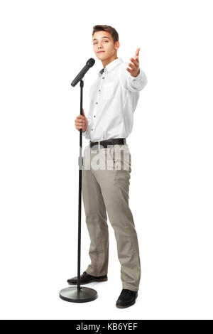 Young man singing into a microphone while pointing forward isolated on white background Stock ...