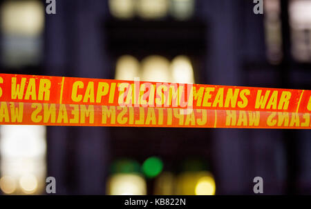 Tape bearing anti-capitalist slogans are photographed in Parliament ...