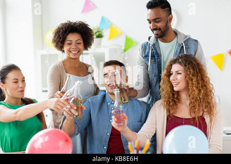 Colleague team drinks beer together at closing time on the office roof ...